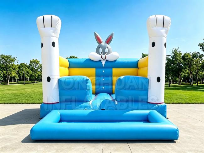 · Rabbit theme inflatable bouncer with cartoon bunny head and bright blue yellow design for kids events