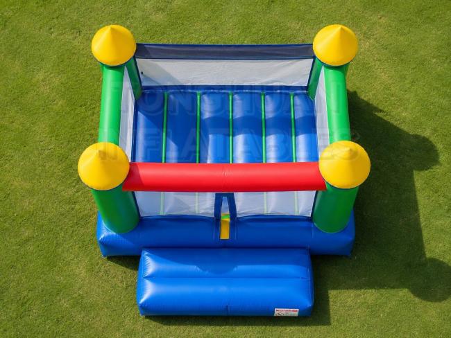 commercial inflatable bounce house with red green blue and yellow castle tower design