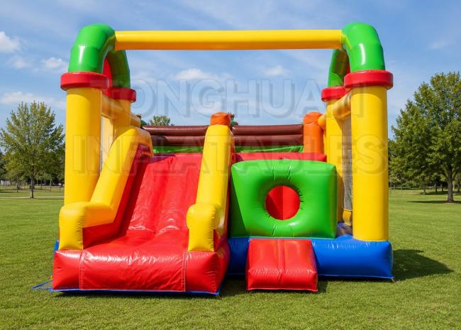 inflatable bounce house with bright red yellow green and blue castle frame design