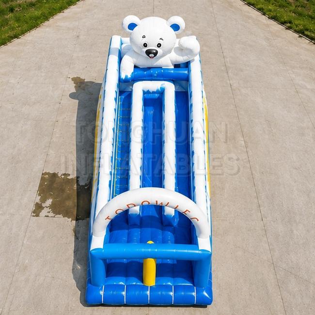 outdoor inflatable slide bouncer with blue white snow artwork and arch entrance