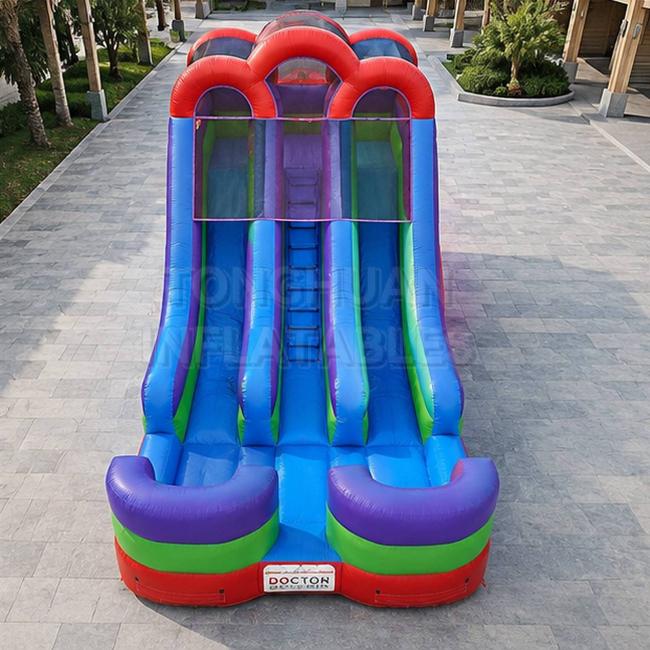 commercial inflatable slide with double lanes bright colors and soft landing area