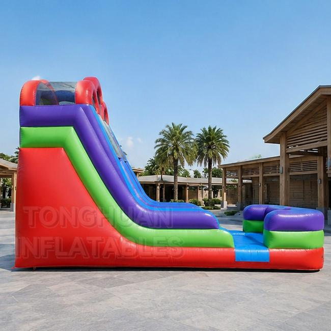kids inflatable dry slide with red purple green and blue outdoor play design