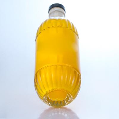 Cina Bottiglia di vetro per bevande industriali con disegno in rilievo e forma rotonda di sughero in vendita