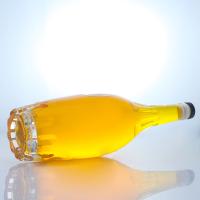 China Customization Round Shape Liquor Bottle with Embossed Design and Customized Cork Cap for sale