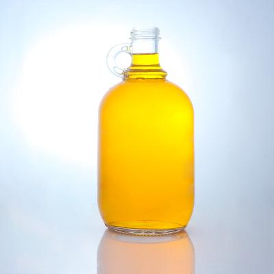 Cina Logo personalizzato Bottiglia di vetro di liquore a forma rotonda con manico e tappo a vite in vendita