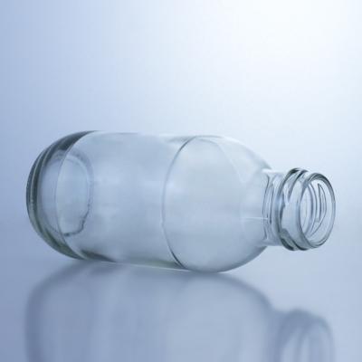Cina 300 ml Bottiglia rotonda di latte in vetro con coperchio Soluzione di conservazione liquori Manipolazione della superficie deccale in vendita
