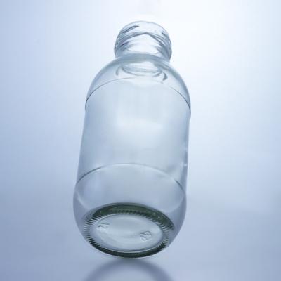 Cina 300 ml Bottiglia rotonda di latte in vetro con coperchio Soluzione di conservazione liquori Manipolazione della superficie deccale in vendita