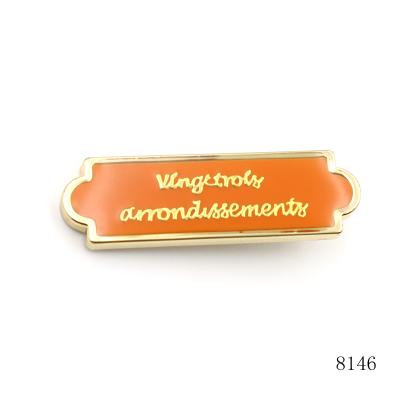 China Gold Plated Zinc Alloy Orange Enamel Metal Tag Custom Metal Logo Plate with Iron Prong Feet for sale