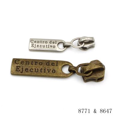 China Engraved Custom Logo  Metal Zip Puller Tag Rolling Anti Brass Pull Tag For Handbags Hardware Accessories for sale