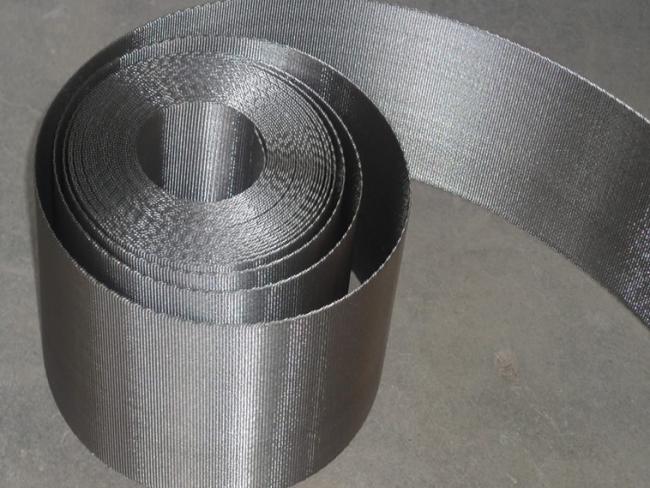 A roll of stainless steel extruder screen belt on the ground with bright color.