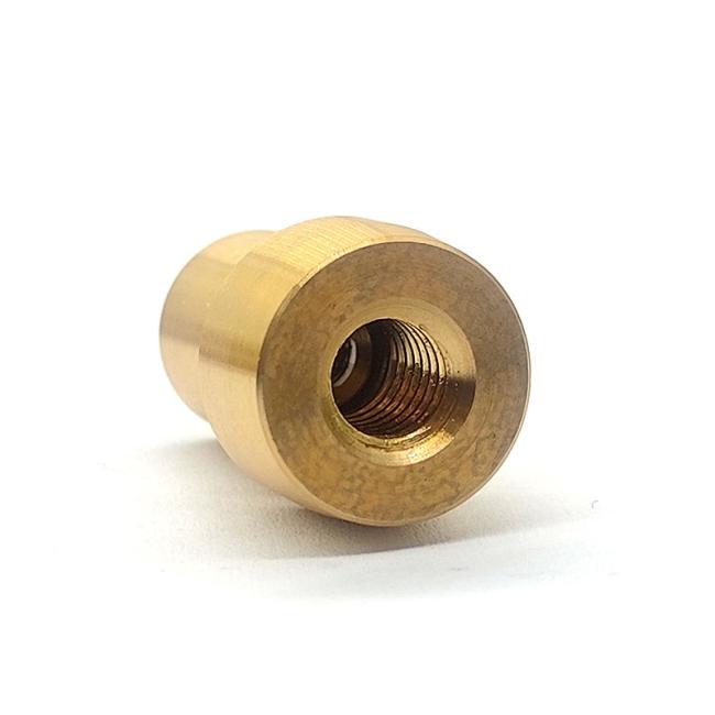 Brass machined components on workbench