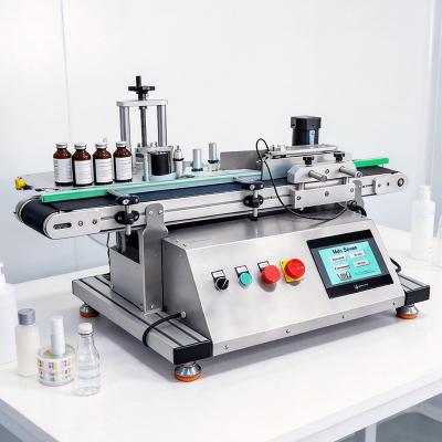 China Automatic Desktop 100ml 300ml 500ml 800ml Water Bottle Labeling Machine for Glass and Plastic Bottle Label Applicator for sale