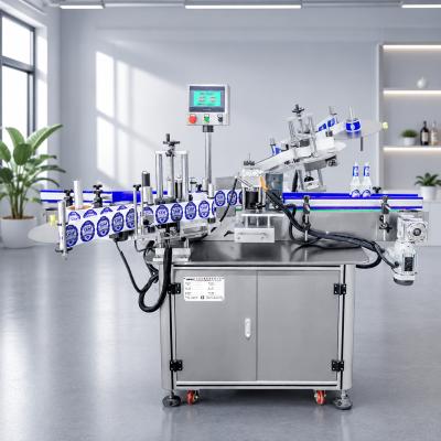 China Double Head Automatic Labeling Machine Round Bottle Beer And Coke Bottle Labeler Machine With Bottle Clamping Mechanism for sale