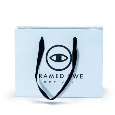 China Durable high quality promotion gloss glasses packaging paper bag for sale