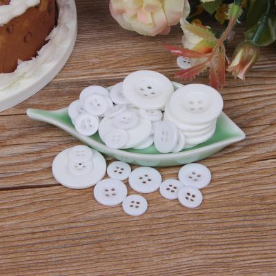 China Custom Manfactur Low MOQ 14L Lettering White Ivory Resin Jeans Shirt Round Button For Clothes Resin Button 4 holes for sale