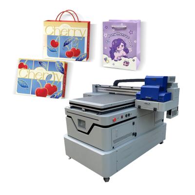 China Multifunction 6090 UV FlatBed Machine Print Phone Case Glass Bottle Pen PVC Acrylic Ceramic Wood Metal for sale