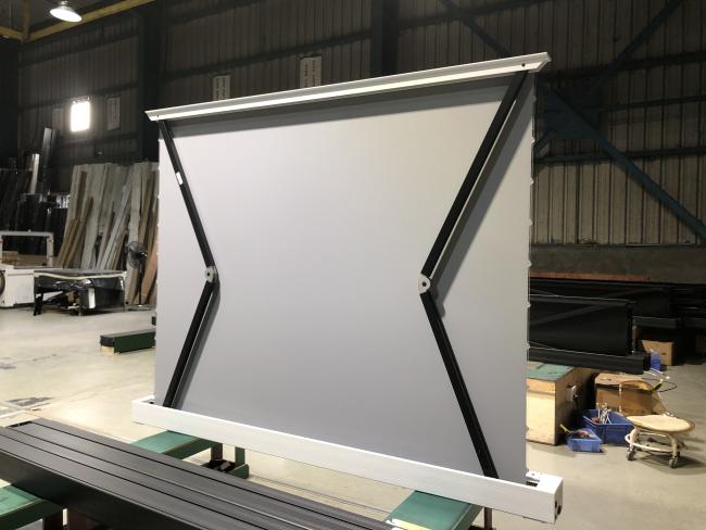 Portable floor-standing projector screen in use