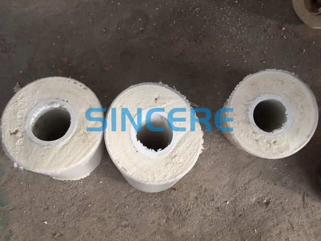 Pipe insulation machine in operation showing full production line