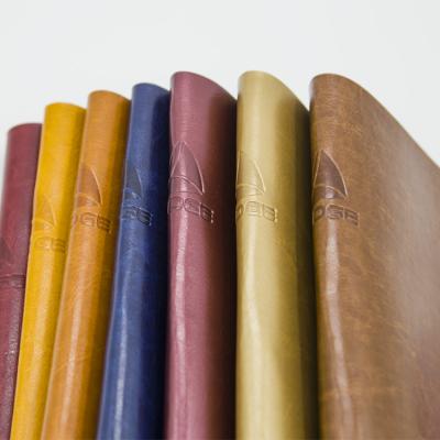 Cina Abrasion-resistant hot stamping custom printed color change pu faux leather fabric vegan leather for notebook in vendita