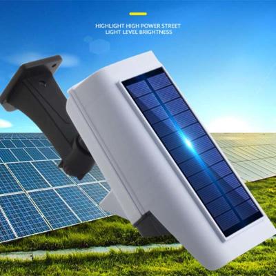 China 2 In 1 Solar Light Security Dummy Camera Motion Sensor Outdoor Solar Wall Lamp Rainproof for sale