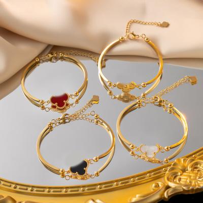 China Popular Waterproof Black Red Clover Bangle 18K Gold Stainless Steel Gold Four Leaf Clover Bracelet Bangle for sale
