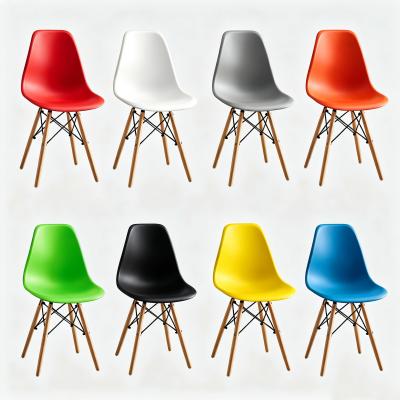China Modern Plastic Dining Chair with Nordic Wooden Legs and X-shaped Iron Frame for 450mm Seat Height for sale