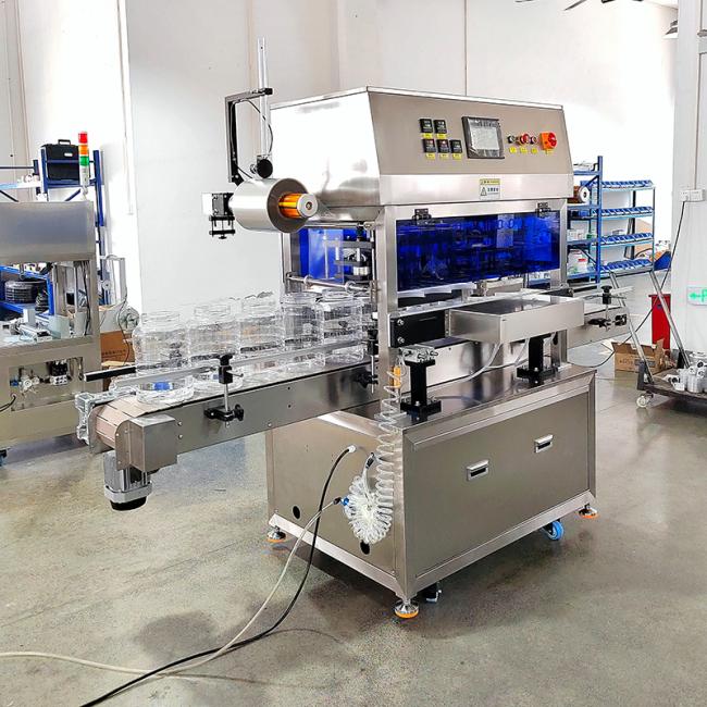 Close-up view of sealing mechanism on oatmeal barrel machine