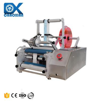China Round Bottle Labeling Machine Beer Cans Wine Adhesive Sticker Dispenser Machine Manual Can Labeler for sale