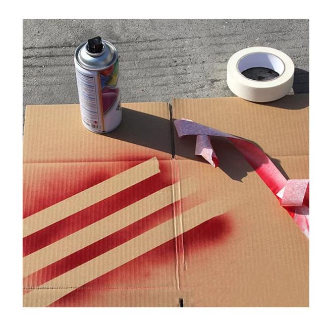 White masking tape roll showing adhesive side and crepe paper texture
