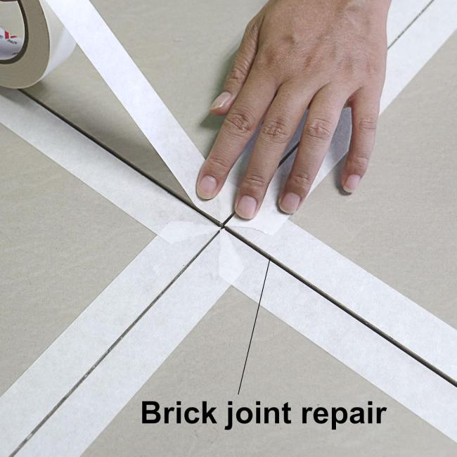 Close-up of masking tape adhering to a painted surface