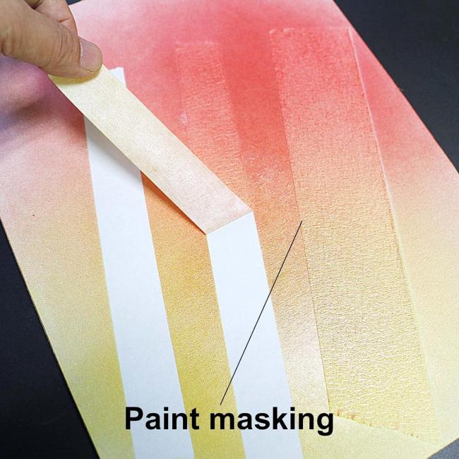 Masking tape being applied to a curved surface for painting