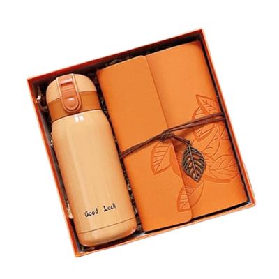 China Customized Color Orange Fashion Entry Gift with Hand Warm Cup Notebook Good Luck Pendant for sale