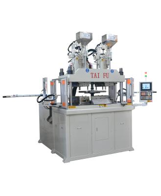 China 120 toneladas raspadora con manija máquina de fabricación vertical de dos colores máquina de moldeo por inyección en venta