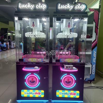 China Brazil Popular Arcade Clip Mini Game Machine Lucky Clip Prize Machine 24 Clips Coin Operated Machine for sale