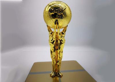 China Shiny Gold Plated Custom Trophy Cup With The Statue Holding The Ball Design for sale