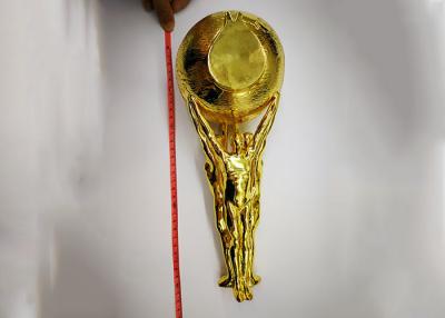 China Shiny Gold Plated Custom Trophy Cup With The Statue Holding The Ball Design for sale