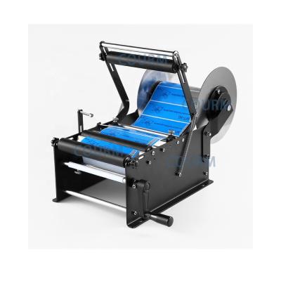 China COURM Simple industrial hand-held manual round bottle labeling machine Plastic can small bottle widening flat labeling machine for sale