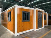 China 20ft Expandable Container House with Wood-Grain Cladding and Dark Grey Window Frames for sale