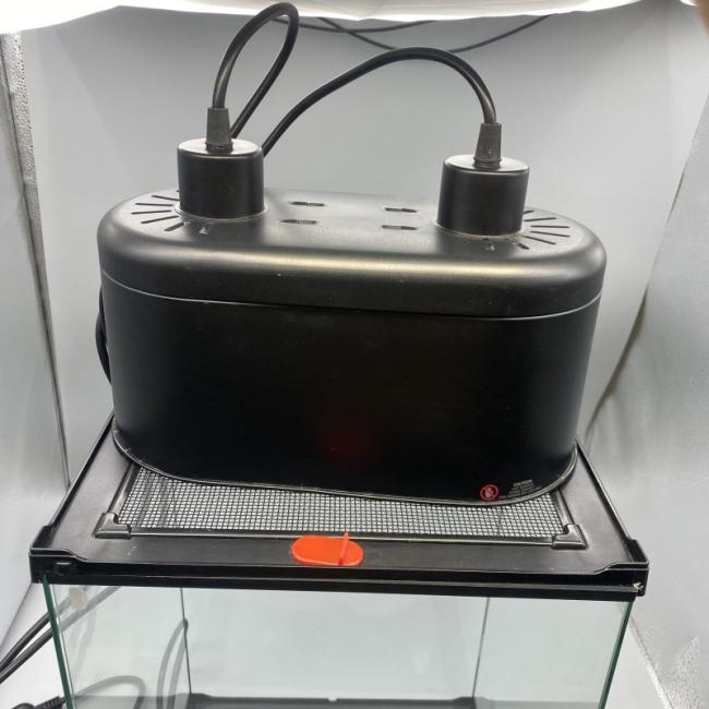 Close-up of reptile lamp showing ceramic socket and ventilation holes