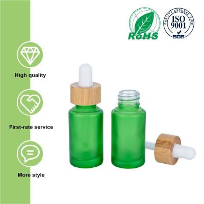 China 30ml Frosted Green Glass Dropper Bottles Essential Oil Bottle With Bamboo Dropper for sale