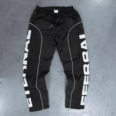 China Design Polyester Letter Wholesale Nylon Pants for Men Custom Patchwork Elastic Waistband Track Printing Flare Men'S Pants for sale