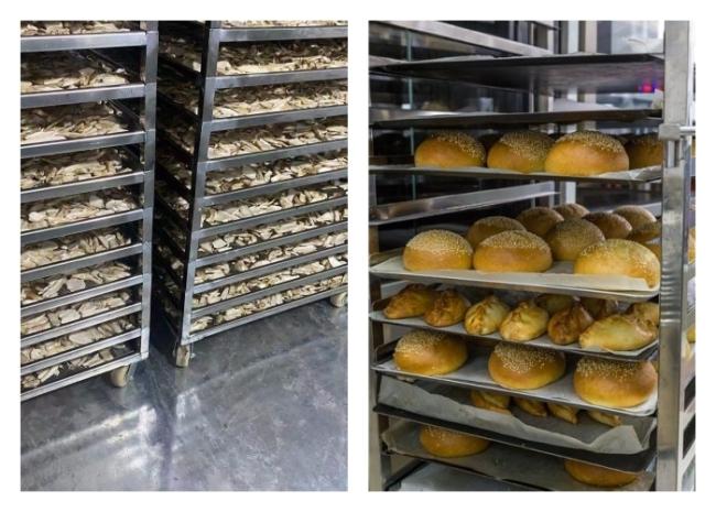 Stainless steel baking tray trolley in commercial kitchen setting
