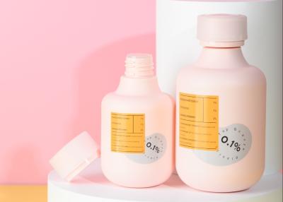中国 100ml化粧品のクリーム色の血清のピンクのふたが付いているプラスチックびんの瓶 販売のため