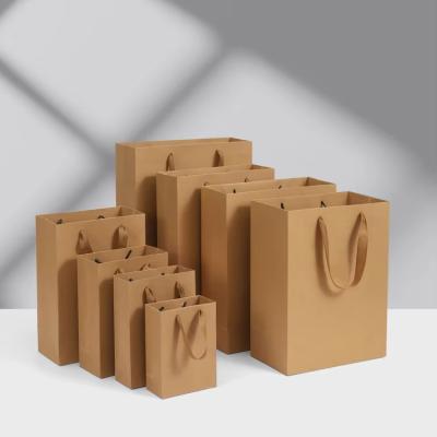 China Customizable Handcrafted Sustainable Luxury Kraft Paperboard Bag With Ribbon Handle for sale