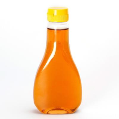 China Transparent Plastic Honey Bottle 500ml PET Food Container with Silicone Valve Custom Logo for sale