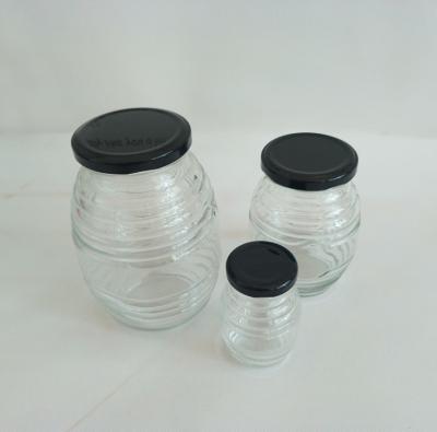 China Honey Jars Transparent Spiral Storage Tank High soda-lime Glass jar with metal screw lid for sale