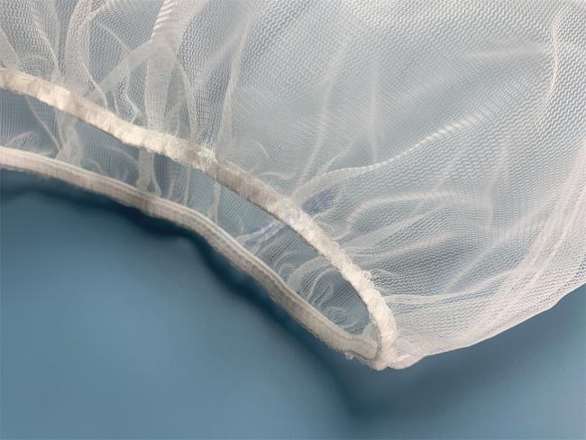 Mesh filter bag in use with paint bucket