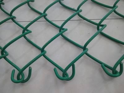 A part of chain link fence with twist ends is placed on the floor.