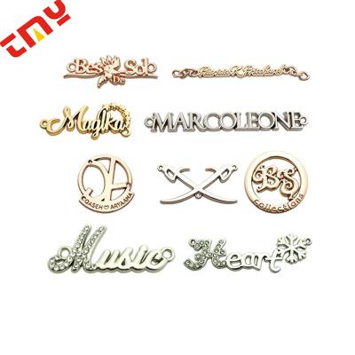 China Custom Mini Letters Metallic Label Accessories Manufacturer Personalized Design Logo Engraved Metal Clothes Tags for sale