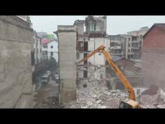 The 15-meter Long boom of the Hyundai 150 is used for demolishing buildings